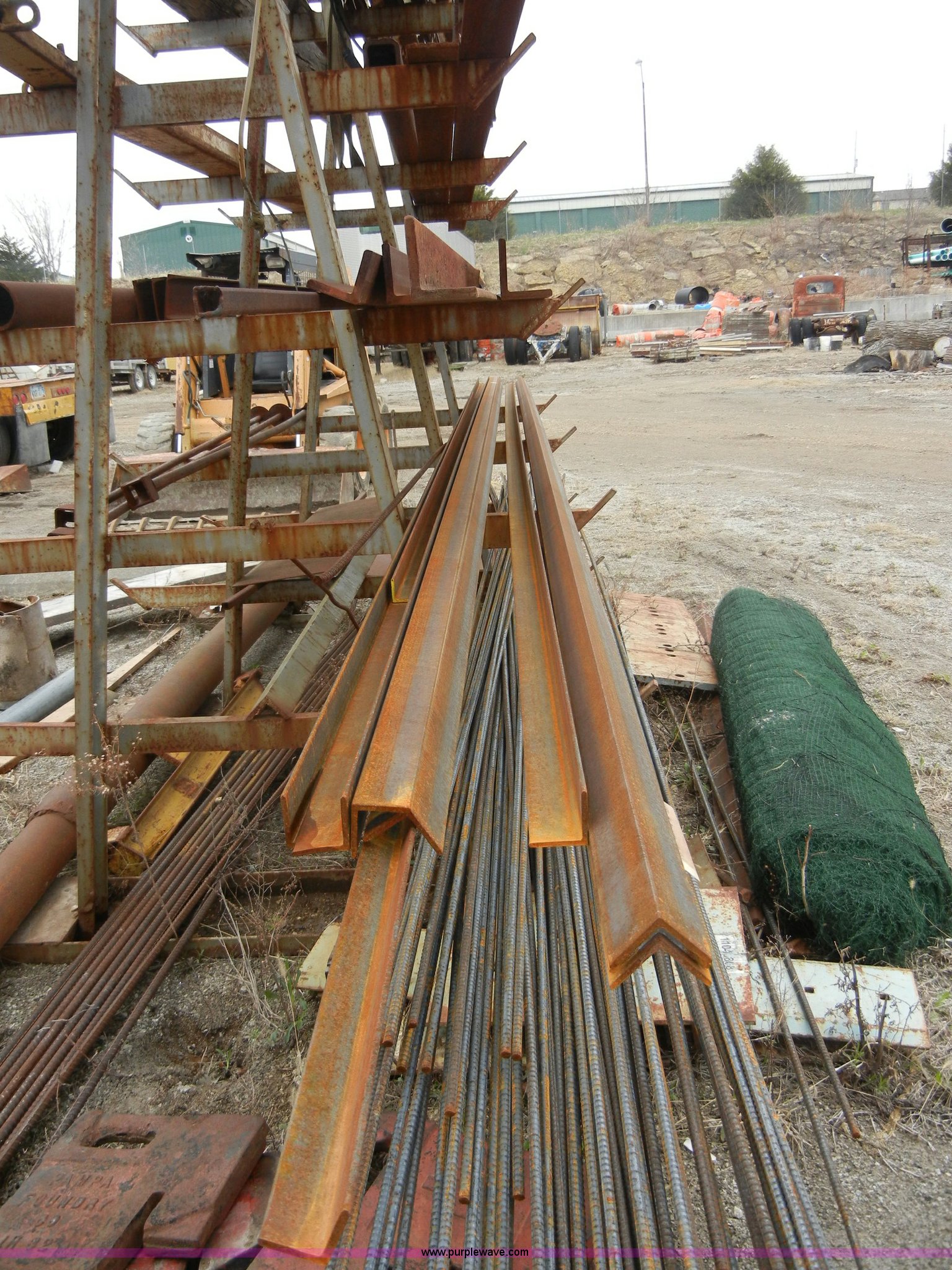 Assorted angle iron rebarb and scrap iron, metal tubing with rack in ...